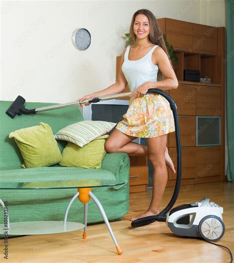 Female In Skirt Cleaning With Vacuum Cleaner Foto De Stock Adobe Stock