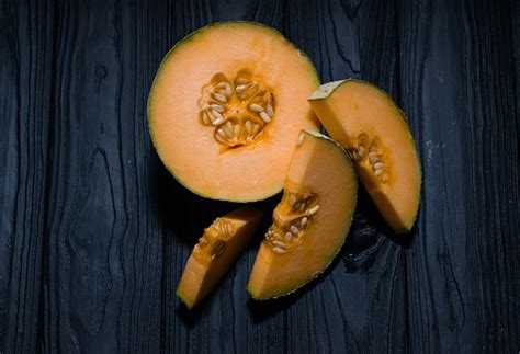 어두운 배경에 달콤한 멜론 작은 맛있는 아름다운 멜론 전체와 조각으로 모두 접혀 먹기 위해 0명에 대한 스톡 사진 및 기타