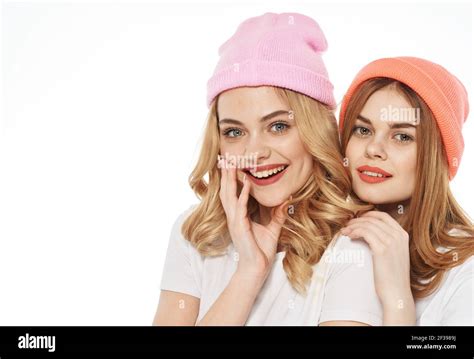 Two Sisters In Multi Colored Caps Hug Together Friendship Communication