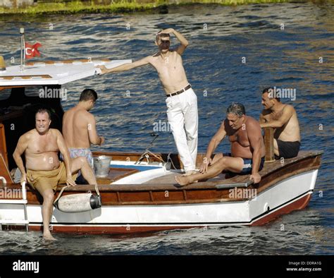 Turkish Men Sunbathing On Boat At Bosphorus Strait Istanbul Turkey