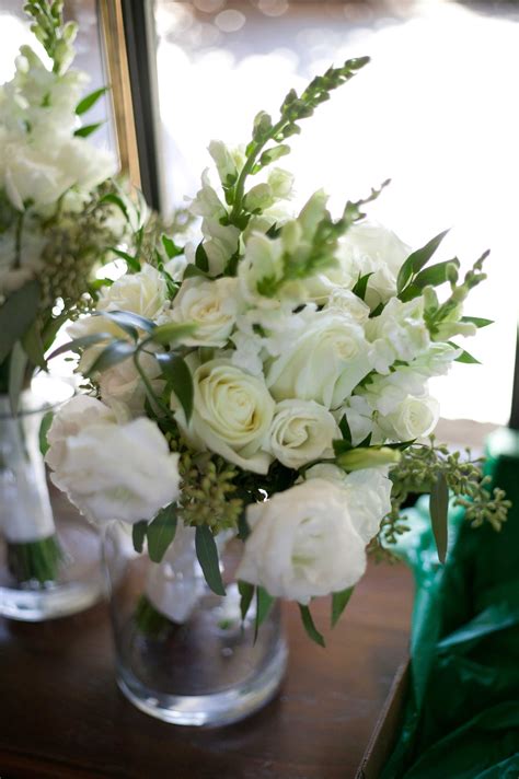 White Flower Bouquet With Green Leaves In Glass Vase