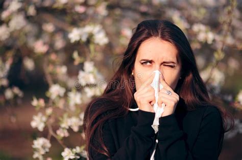 Sick Girl Blowing Her Nose Outdoors In Spring Season Stock Image