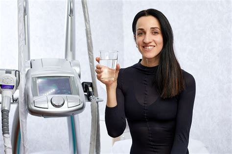 Woman In A Black Suit For Lpg Massage Drinking Water Before Lpg Massage