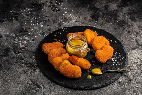 Fried Crispy Chicken Nuggets With Mustard Honey Sauce On Stone Board