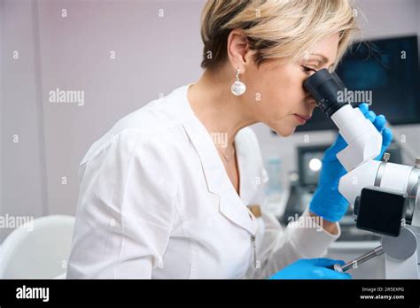 Close Up Photo Of Gynecologist Woman Who Looks Through Microscope Stock Photo Alamy