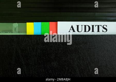 Hand Picking Audit Report File Record In Black Binder Folder Auditing