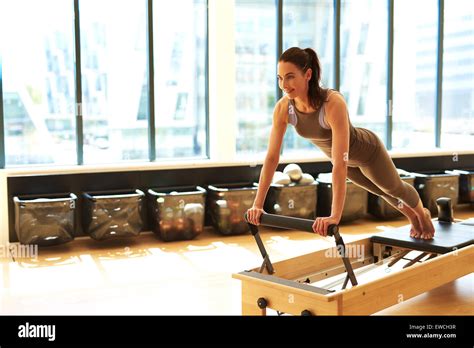 Healthy Smiling Brunette Woman Wearing Leotard And Practicing Pilates
