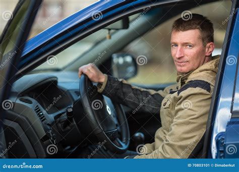 A Young Man Sits Behind The Wheel Of A Car Work Stock Image Image