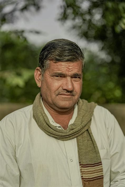 A Man With A Scarf Around His Neck Photo Free Portrait Image On Unsplash