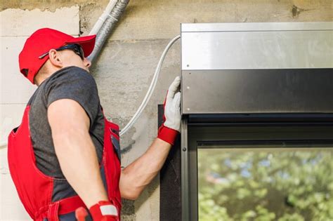 Premium Photo Worker Installing Automatic Outdoor Window Shutters