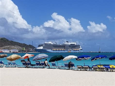 Download Parasols Lining Up At Sint Maarten Shore Wallpaper