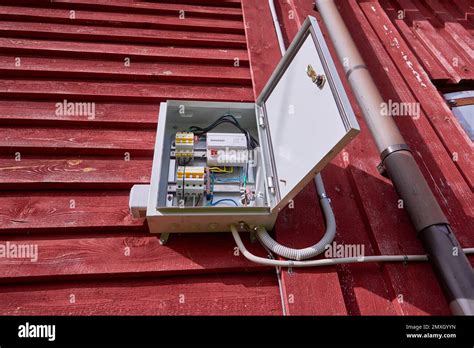 An External Switchboard With An Electric Meter Hangs On Wall Of Wooden