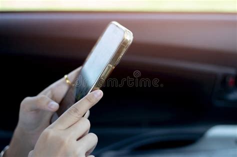 Close Up Shot Of Young Woman Sitting And Using Mobile Phone To Send