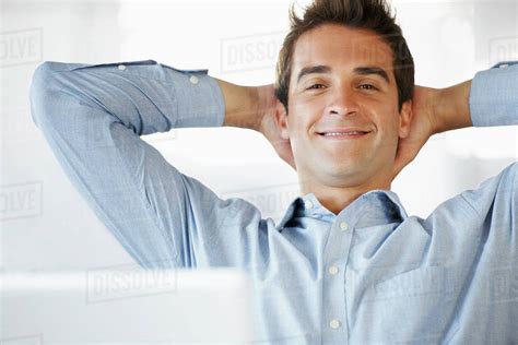 Portrait Of Man Relaxing Hands Behind Head Stock Photo Dissolve
