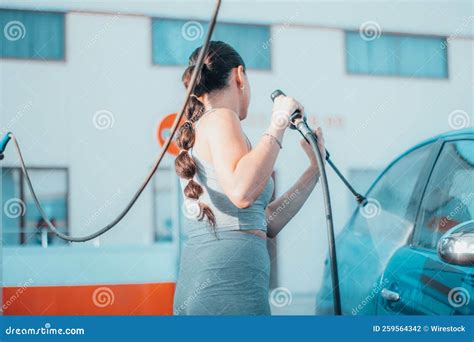 Closeup Of A Beautiful Girl Washing The Car With A Pressure Washer