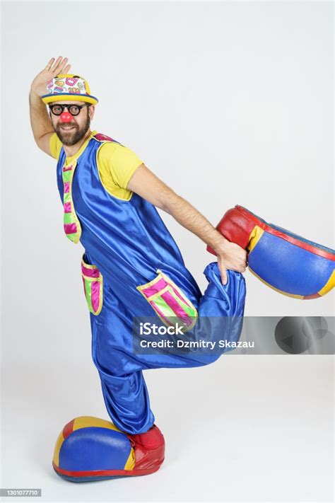 광대는 밝은 파란색과 노란색 정장 안경과 모자를 쓰고 감정적으로 노는 남자입니다 어릿광대 서커스 공연자에 대한 스톡 사진 및 기타 이미지 어릿광대 서커스 공연자 40