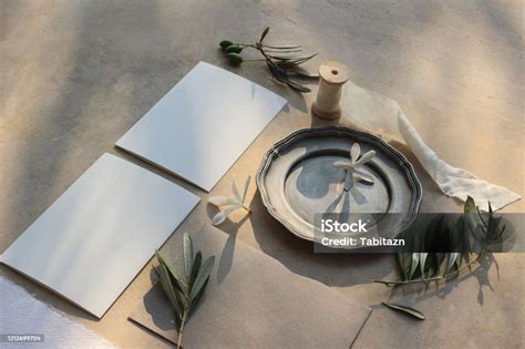 여름 웨딩 문구 모형 장면입니다 빈 인사말 카드 봉투 흰색 꽃 올리브 가지와 실크 리본 실버 플레이트 햇빛 그림자에 대리석 배경입니다 높은 각도 0명에 대한 스톡 사진 및