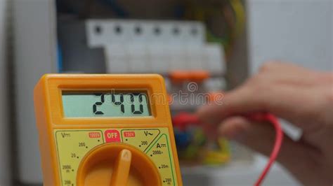 Yellow Multimeter For Measuring Voltage Close Up Work Under Voltage