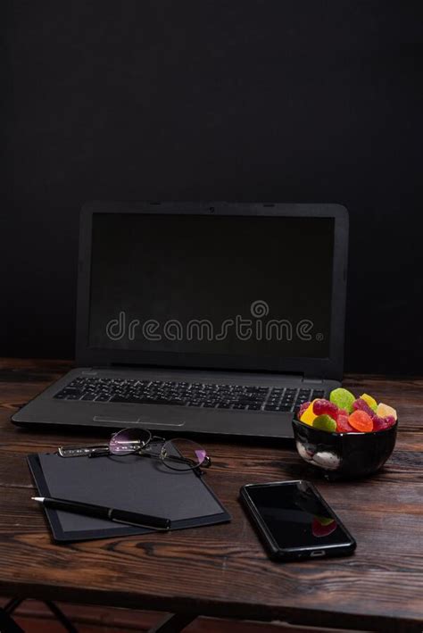 Tablet For Writing And Laptop Multi Colored Sweets On The Desktop