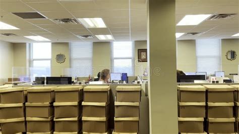 City Office Workers And Stacks Of Boxes In Office Building Setting