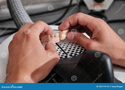 Dental Technician Trimming Excess Material From Plaster Models Dental Technician Trimmed A