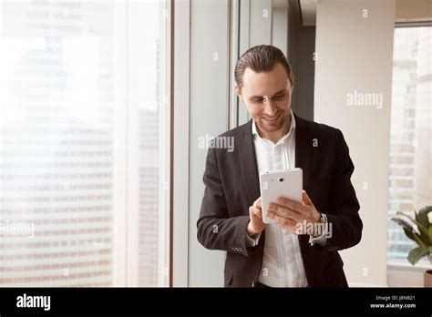 Joyful Businessman Using Computer Tablet For Managing Tasks Organizing