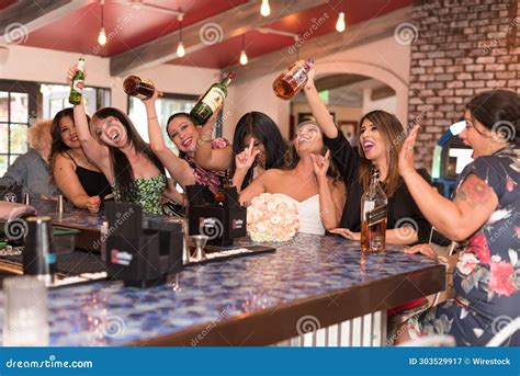 Group Of Women Seated Together At A Bar Conversing Animatedly