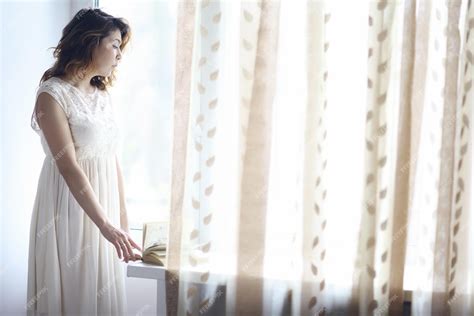 Premium Photo Girl Standing At The Window
