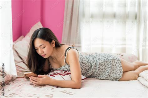 Sexy Chinese Girl Play Smartphone In Bed Stock Photo Adobe Stock