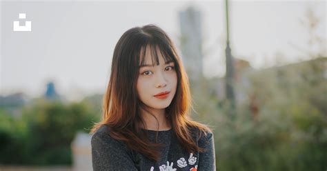 Woman In Gray Sweater And White Pants Sitting On Gray Concrete Floor