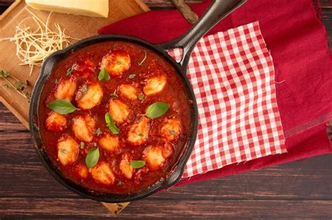 Premium Photo A Pan Of Tomato Sauce With Herbs And Herbs On A Red Cloth