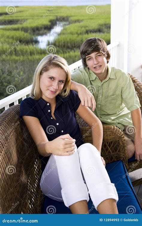 Teenage Siblings Sitting Together On Terrace Stock Photos Image