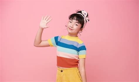 Free Photo Attractive Small Little Friendly Asian Girl Saying Hello Waving Hand At Camera Say