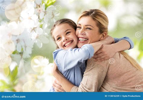 Happy Mother Hugging Daughter Over Cherry Blossom Stock Image Image