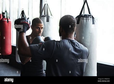 Train Hard Fight Easy A Male Boxer Practising His Moves With His