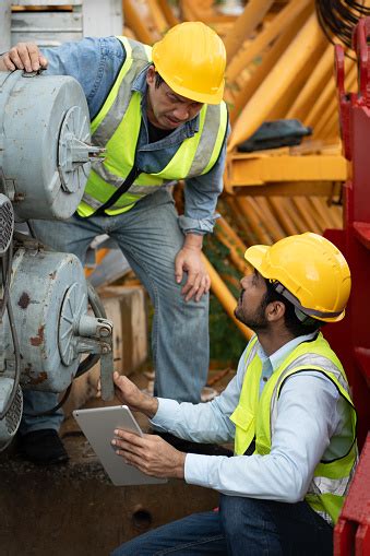 두 명의 아시아 엔지니어가 기계를 검사하는 작업자를 찾고 예비 크레인 배경이 있는 태블릿 컴퓨터를 사용합니다 2명에 대한 스톡 사진 및 기타 이미지 Istock