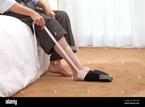 Using A Sock Aid For Putting On Socks Stock Photo Alamy