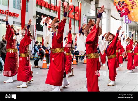Japanese Team Of Yosakoi Dancers Wearing Farmer Straw Hats And Red