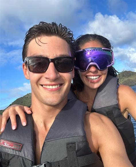 A Man And Woman Wearing Goggles While On A Boat In The Water With Their