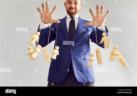 Businessman Playing With Puppets Illustrating Concept Of Manipulation Control And Power Stock