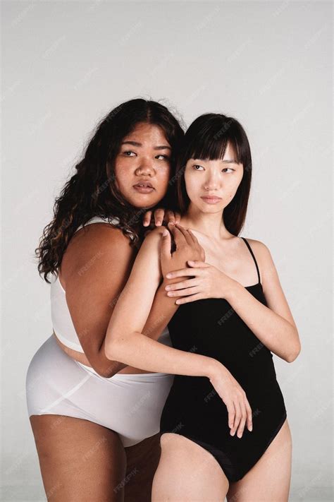 Dreamy Ethnic Lesbian Women In Underwear Near Wall Premium Photo