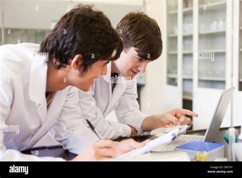 Male Chemistry Babes Writing A Report Stock Photo Alamy