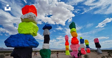 낮 동안 갈색 모래 위에 서 있는 녹색 파란색과 빨간색 모자를 쓴 사람 사진 Unsplash의 무료 조경 디자인 이미지