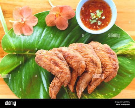 Fried Chicken Wings Served On Leaves With Sauce Top View Crispy