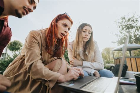 Young Professionals Collaborate In A Vibrant City Discussing Business Ideas And Planning For