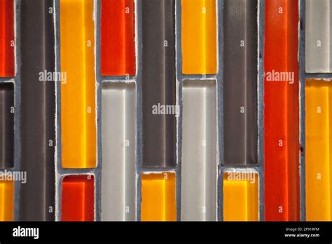 colorful glass vertical rectangular tiled wall close up yellow red
