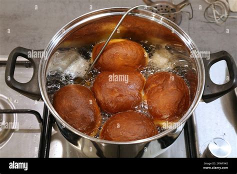 Making Homemade Yeast Raised Donuts Deep Frying In Lard Fat With A Kitchen Thermometer Probe