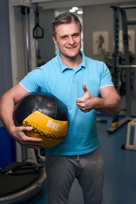 Joyous Athletic Guy Approving Of His Workout During Photo Shoot Stock