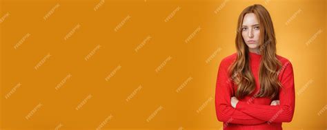 Premium Photo Suspicious Intense And Defensive Ginger Girl Standing In Passiveaggressive Pose
