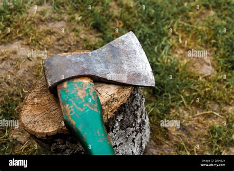 Defocus Steel Ax Closeup Big Steel Axe With Wooden Handle Metal Ax For Wood Chopping Green